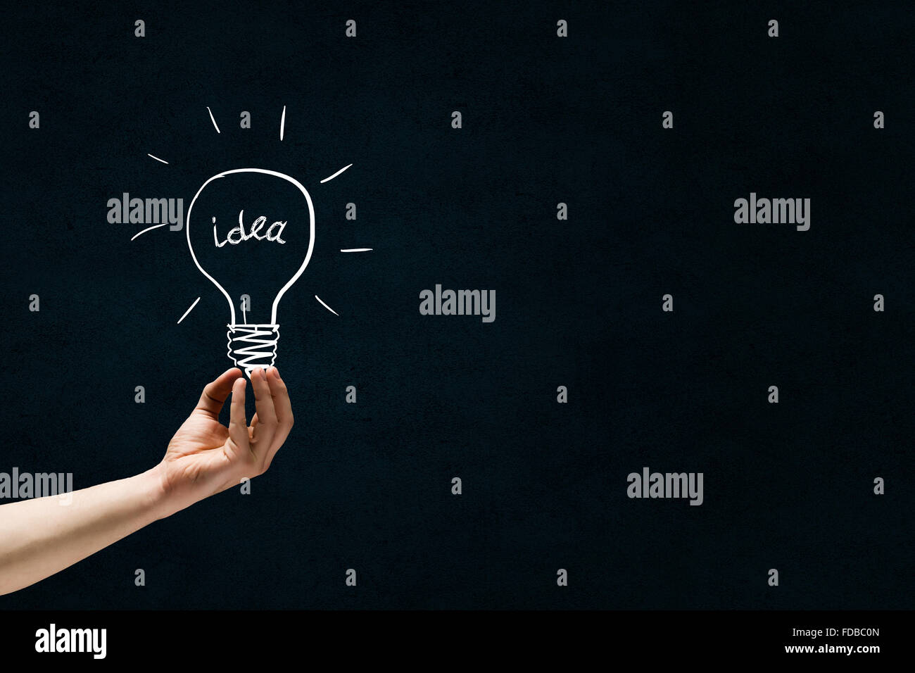 Male hand on dark background showing drawn light bulb Stock Photo - Alamy