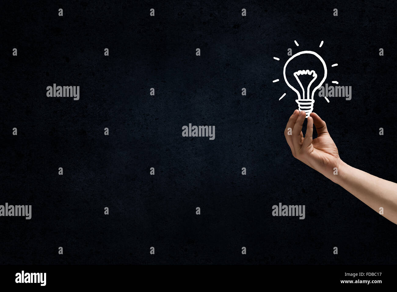 Male hand on dark background showing drawn light bulb Stock Photo - Alamy