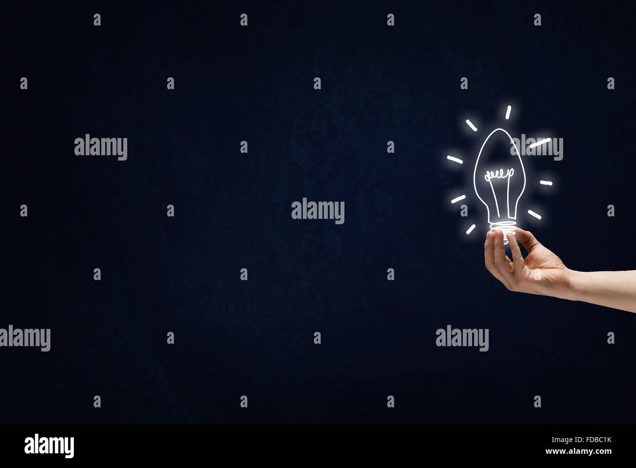 Male hand on dark background showing drawn light bulb Stock Photo - Alamy