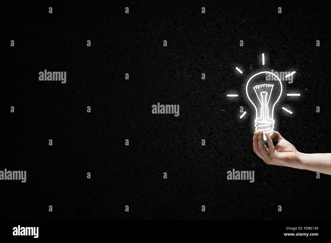 Male hand on dark background showing drawn light bulb Stock Photo - Alamy