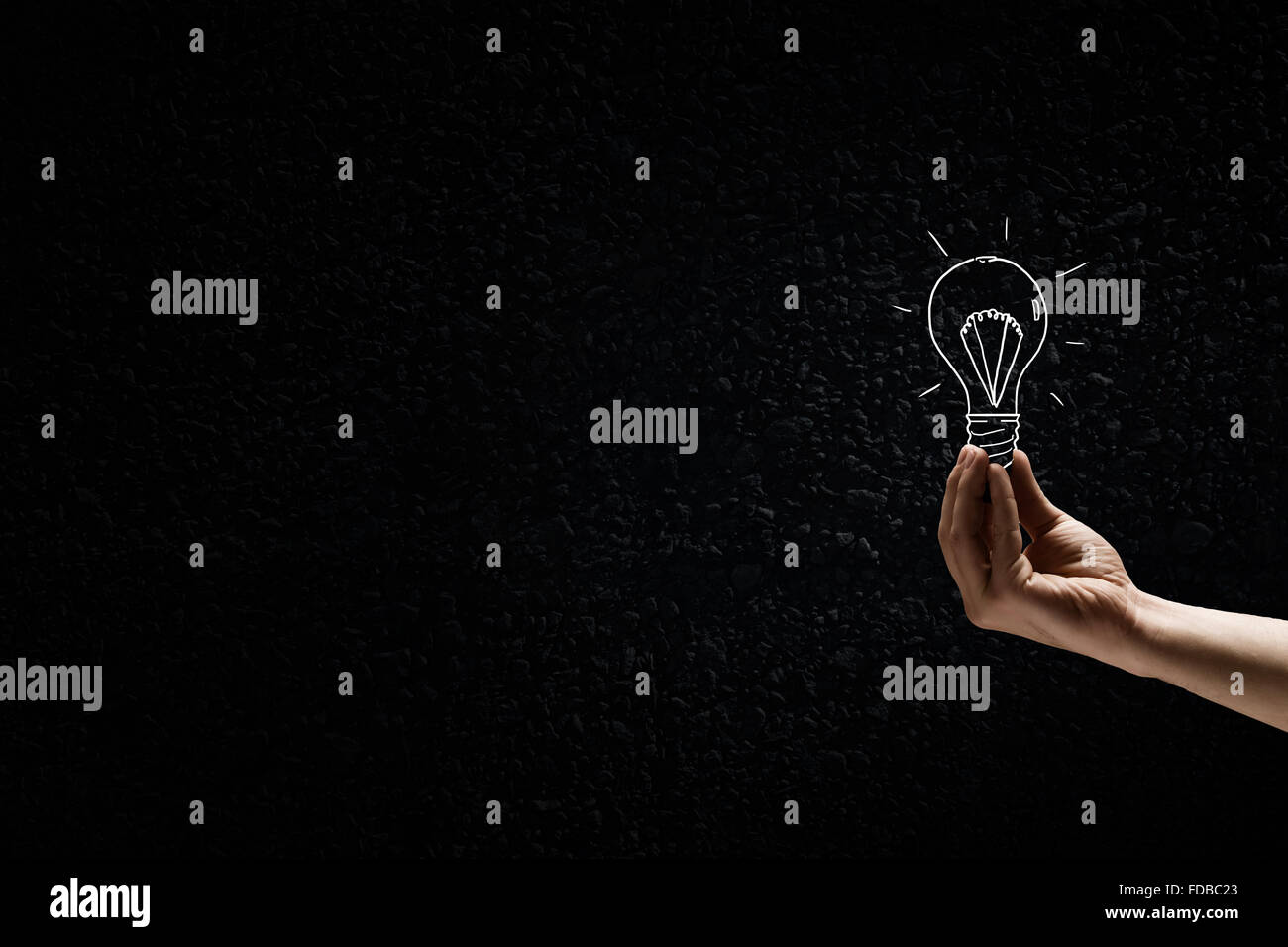 Male hand on dark background showing drawn light bulb Stock Photo - Alamy