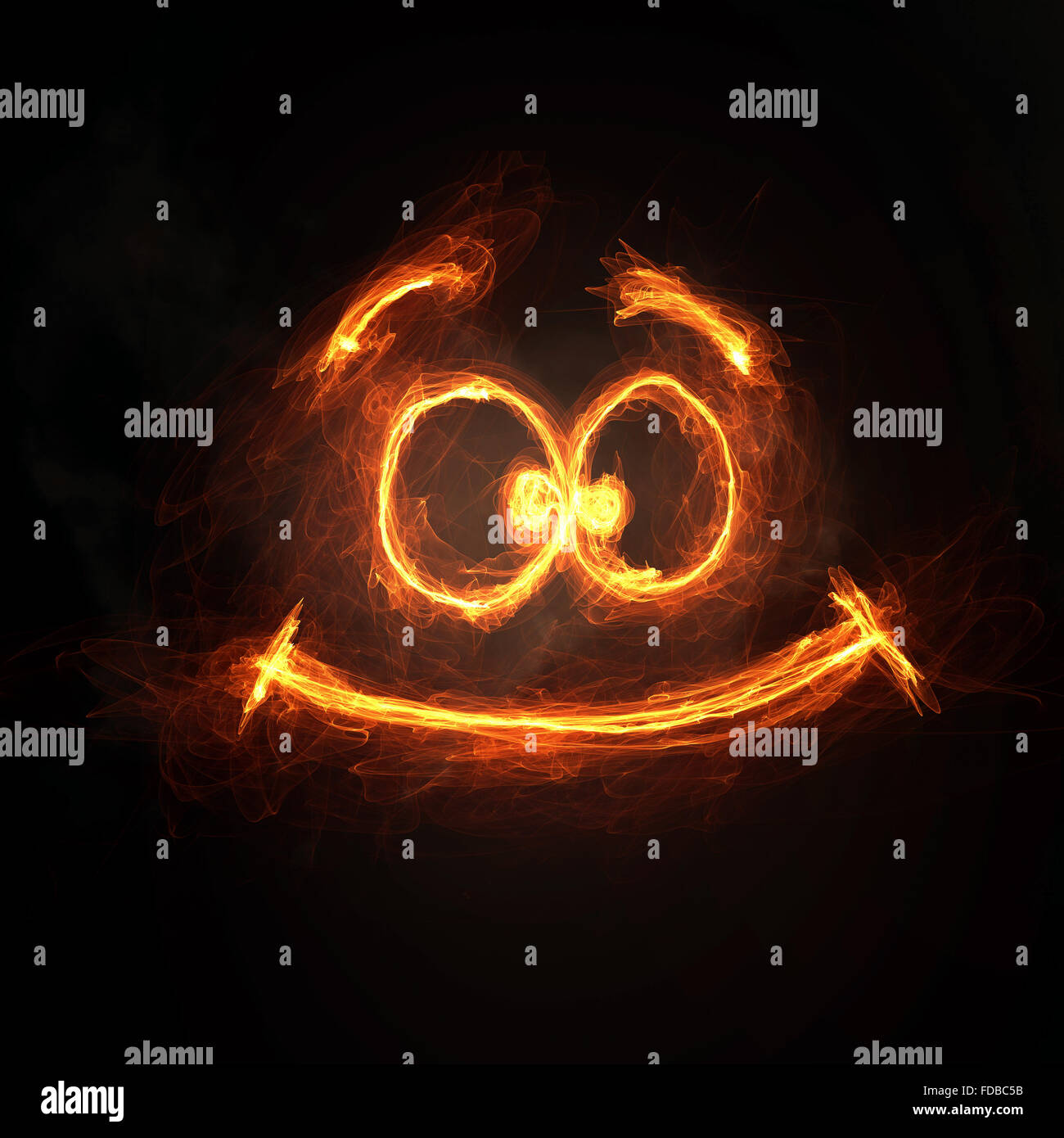 Glowing light smiley symbol on dark background Stock Photo - Alamy