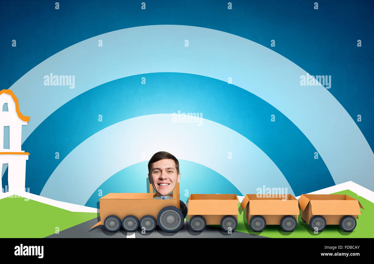 Funny image of businessman riding in carton train Stock Photo - Alamy