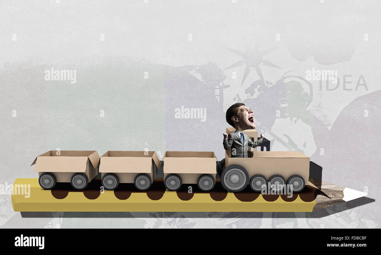 Funny image of businessman riding in carton train Stock Photo - Alamy