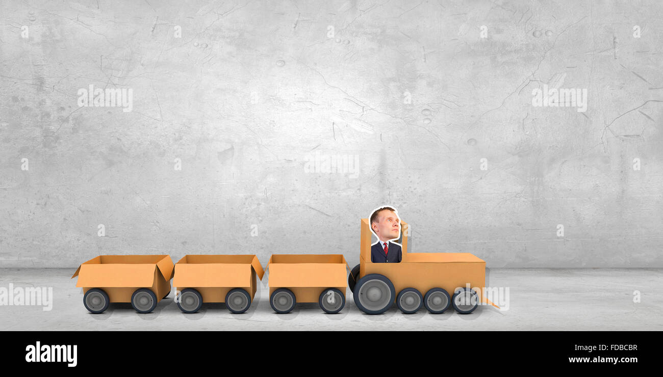 Funny image of businessman riding in carton train Stock Photo - Alamy