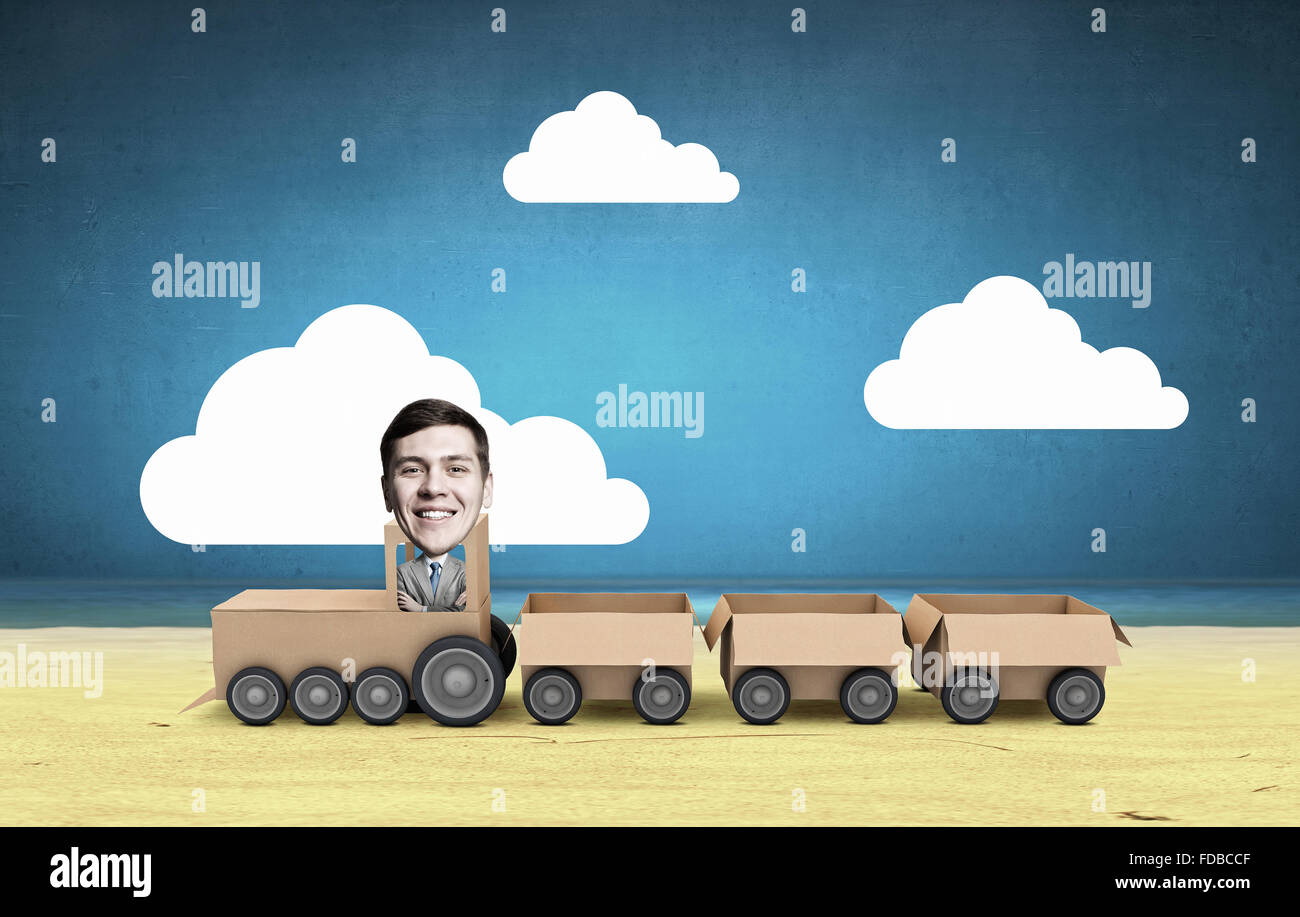 Funny image of businessman riding in carton train Stock Photo - Alamy
