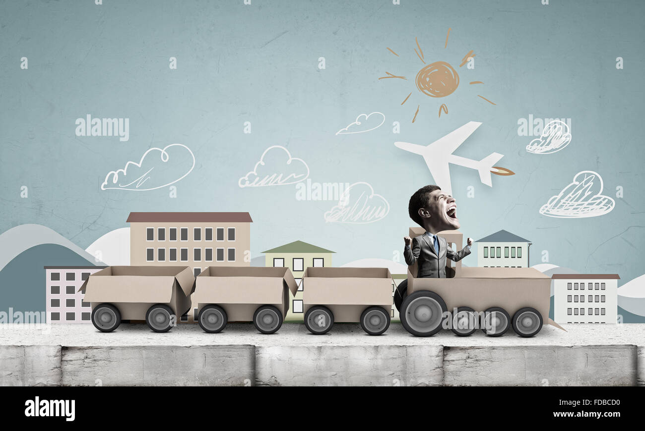 Funny image of businessman riding in carton train Stock Photo - Alamy