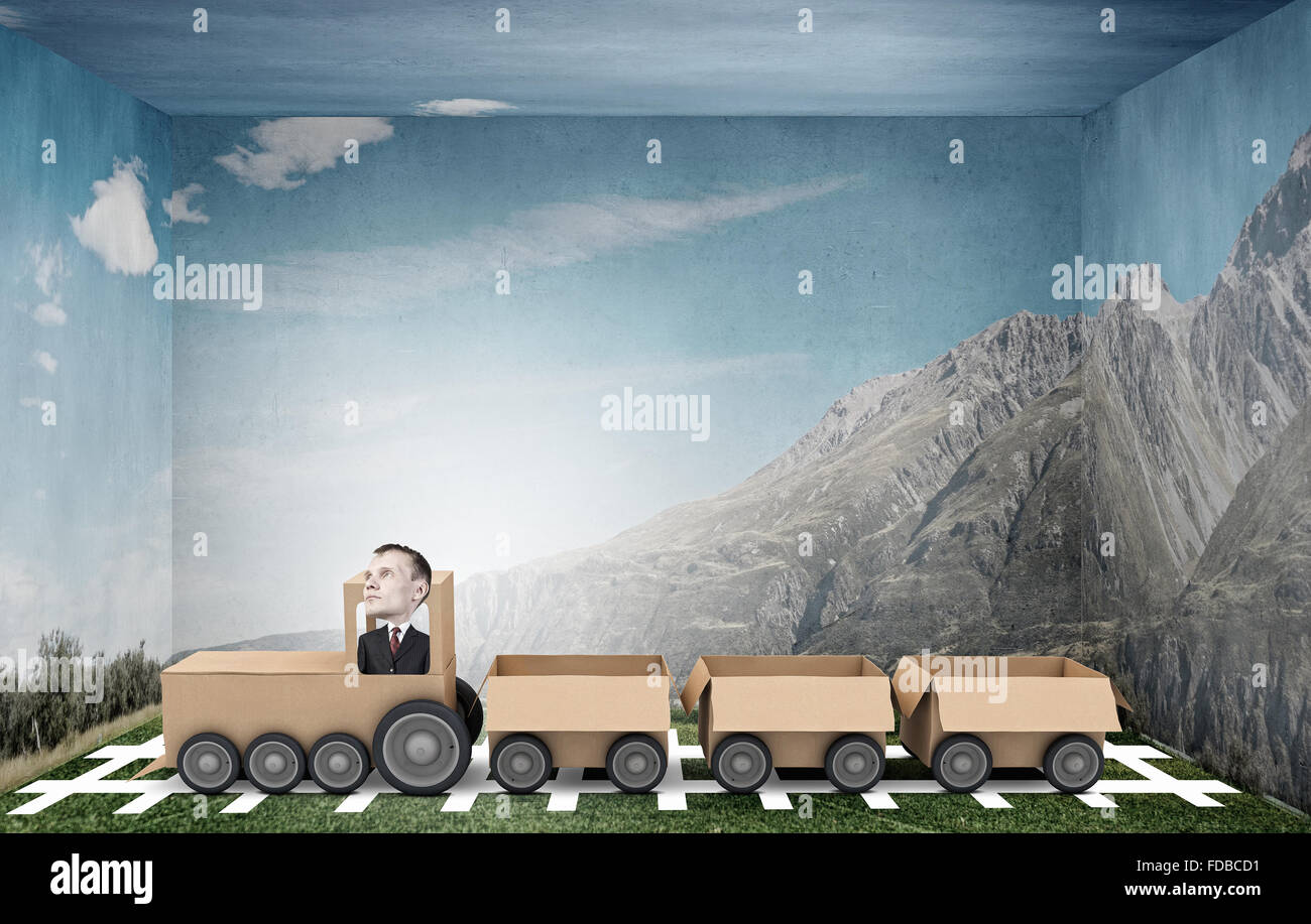 Funny image of businessman riding in carton train Stock Photo - Alamy
