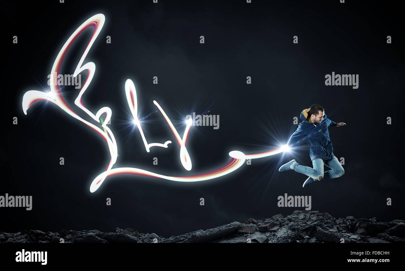 Young man jumping high in sky representing youth concept Stock Photo ...