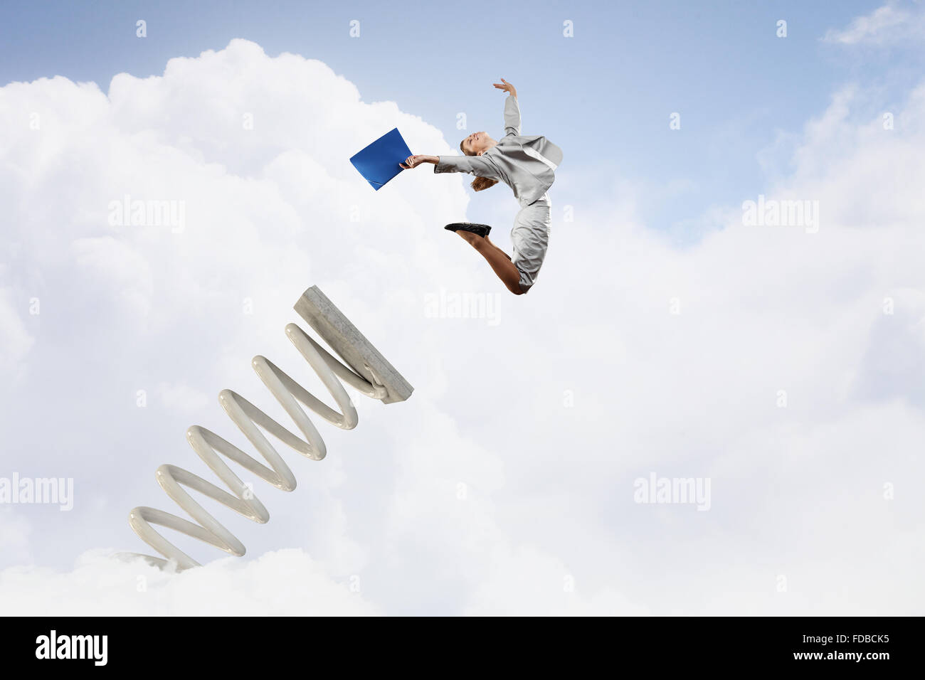 Businesswoman jumping on springboard as progress concept Stock Photo ...