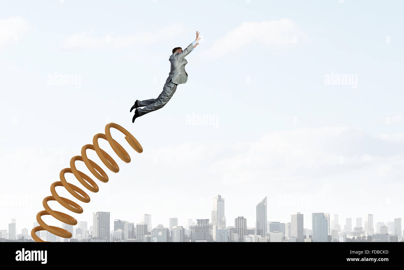Businessman jumping on springboard as progress concept Stock Photo - Alamy