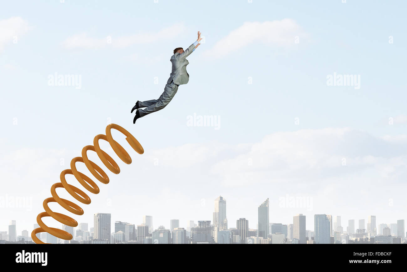 Businessman jumping on springboard as progress concept Stock Photo - Alamy