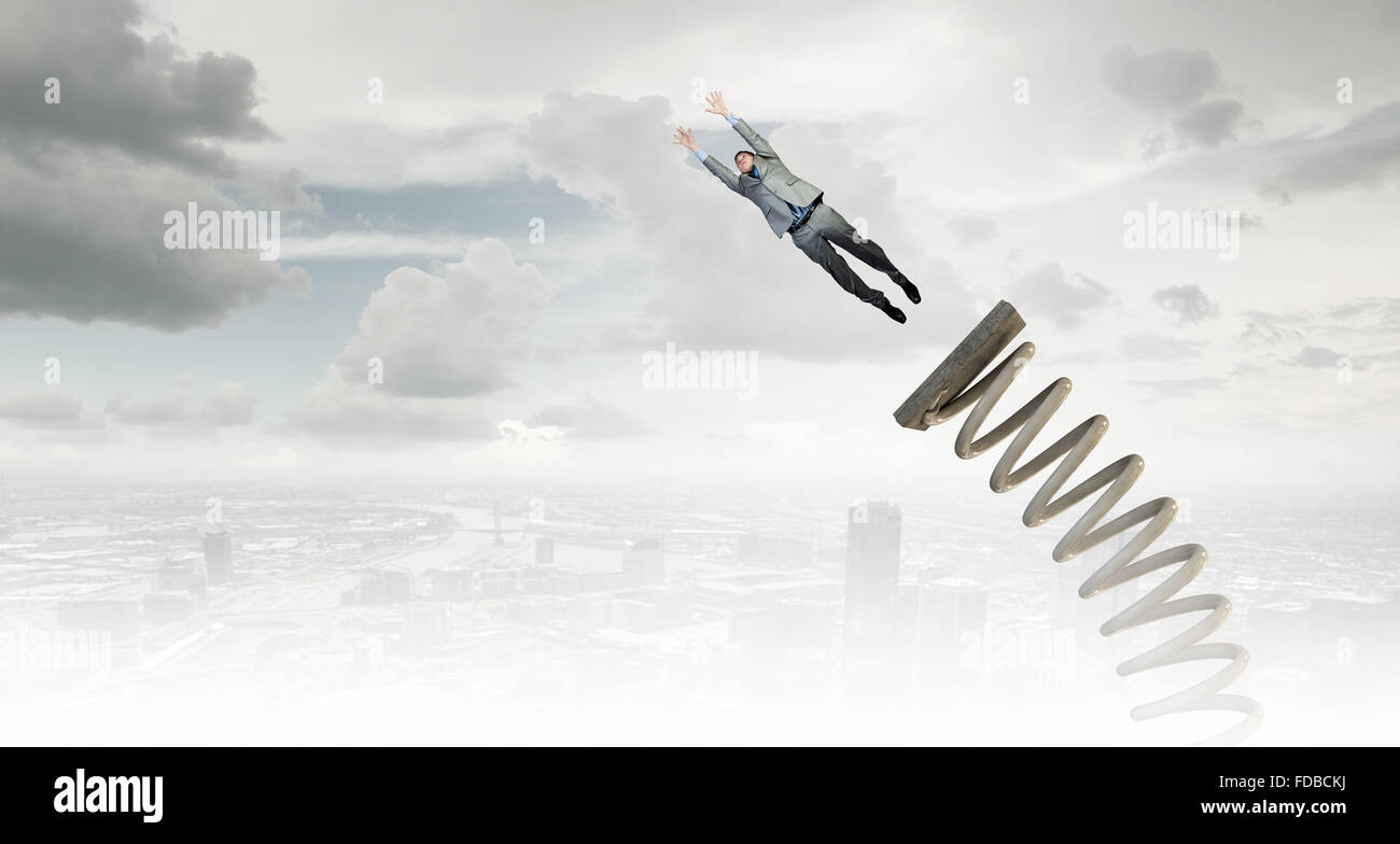 Businessman jumping on springboard as progress concept Stock Photo - Alamy