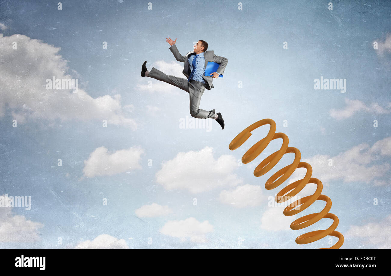Businessman jumping on springboard as progress concept Stock Photo - Alamy