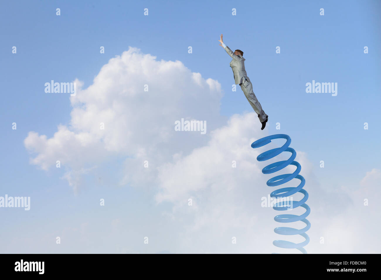 Businessman jumping on springboard as progress concept Stock Photo - Alamy