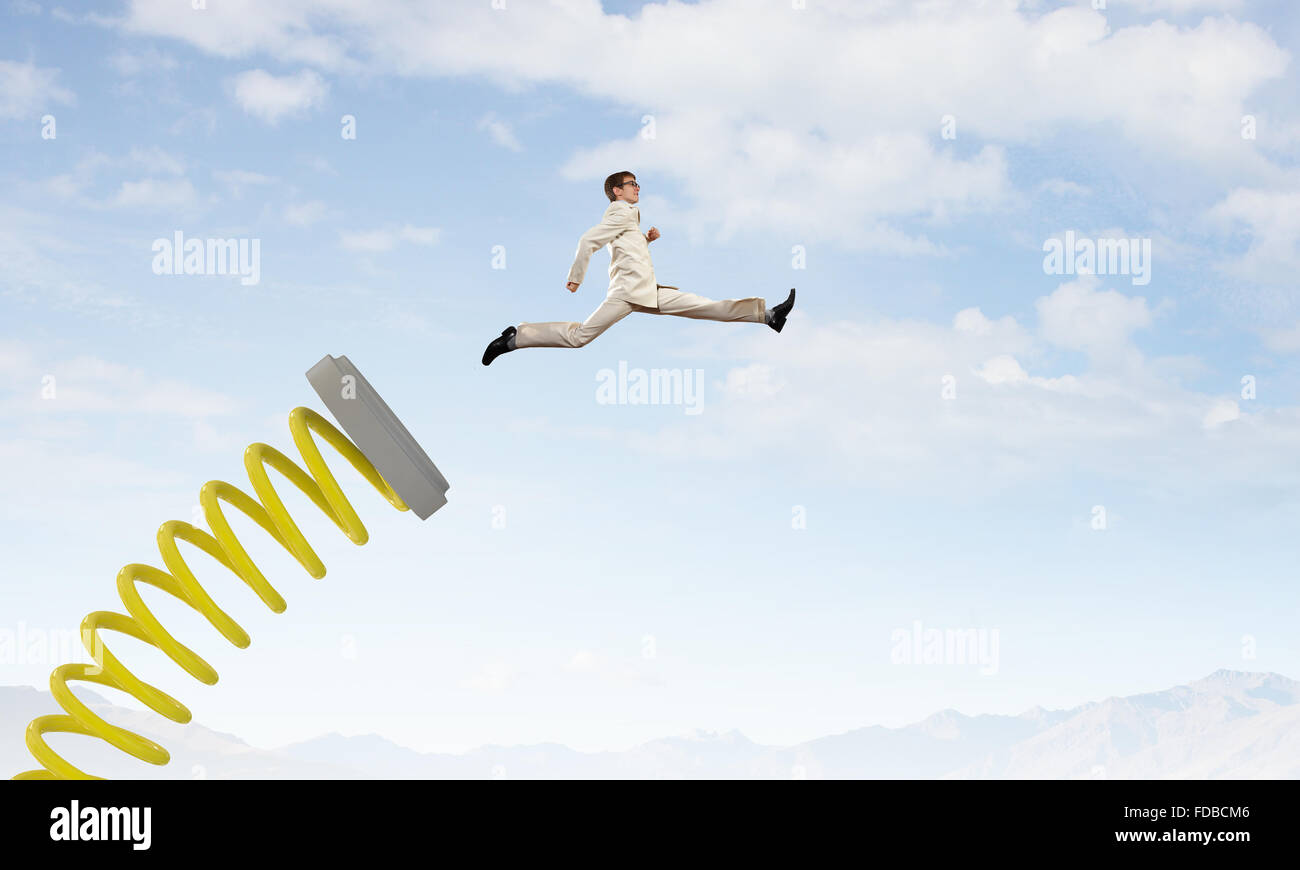 Businessman jumping on springboard as progress concept Stock Photo - Alamy