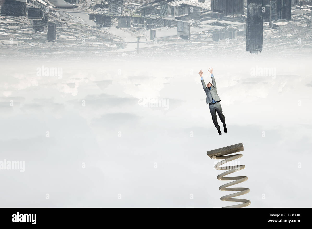Businessman jumping on springboard as progress concept Stock Photo - Alamy