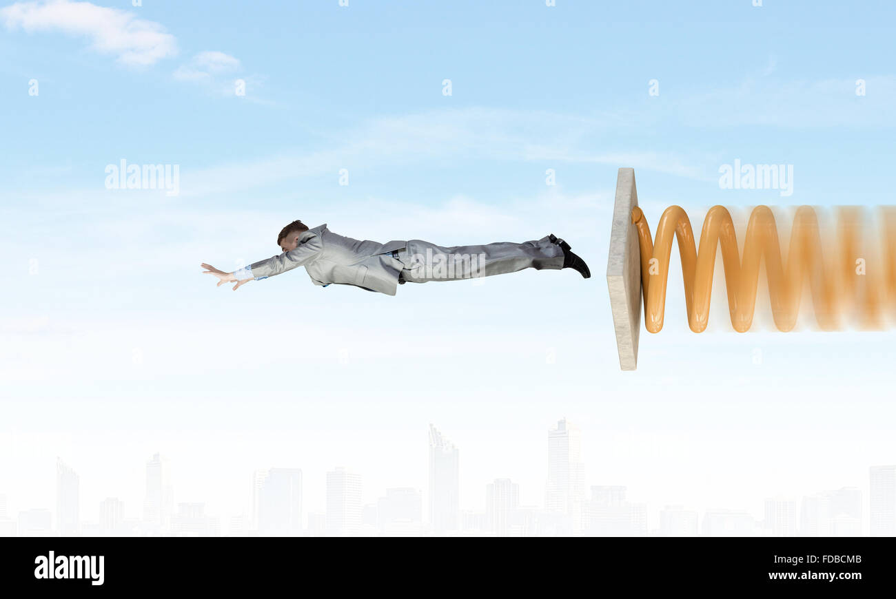 Businessman jumping on springboard as progress concept Stock Photo - Alamy