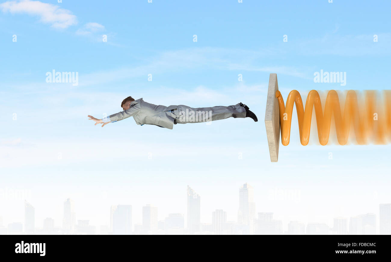 Businessman jumping on springboard as progress concept Stock Photo - Alamy