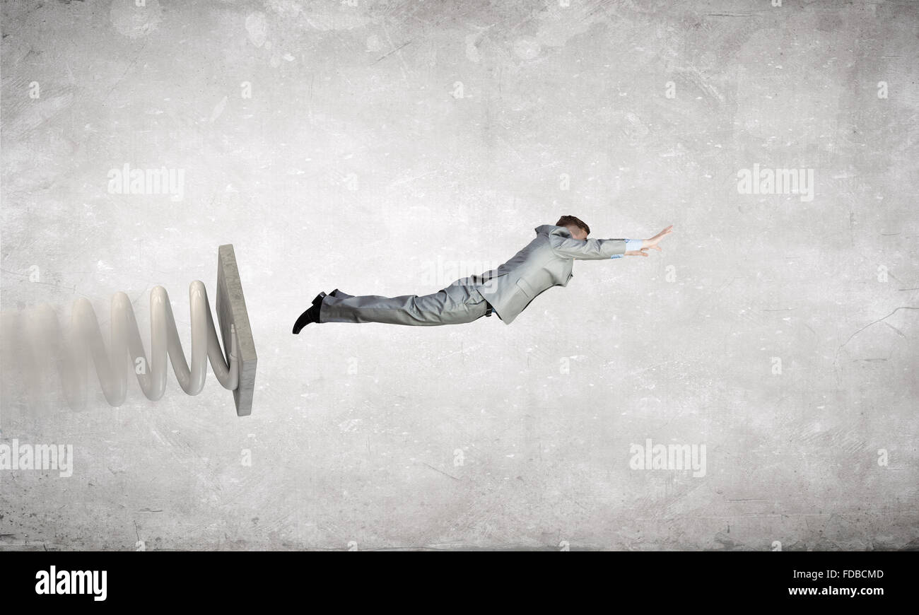 Businessman jumping on springboard as progress concept Stock Photo - Alamy