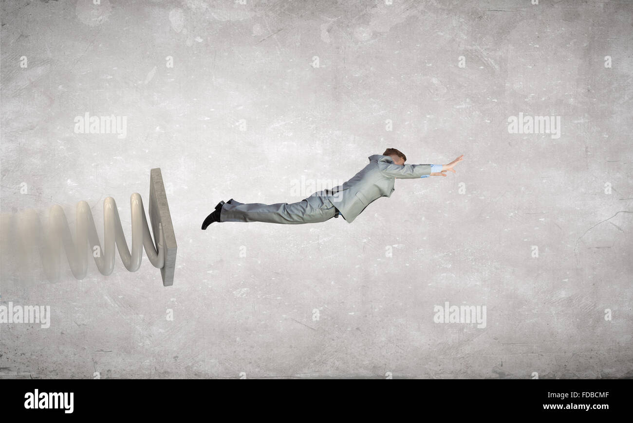 Businessman jumping on springboard as progress concept Stock Photo - Alamy