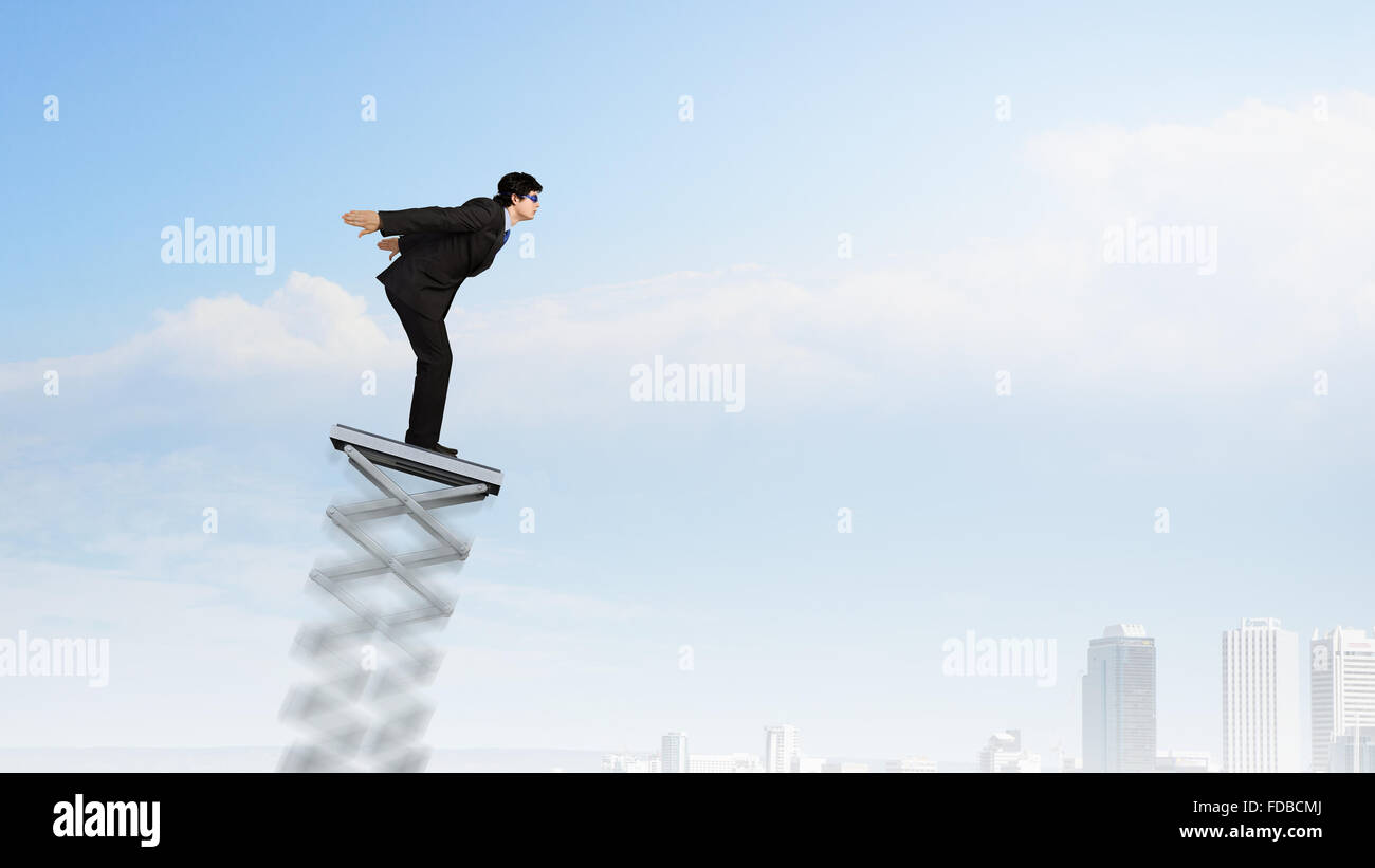 Businessman jumping on springboard as progress concept Stock Photo - Alamy