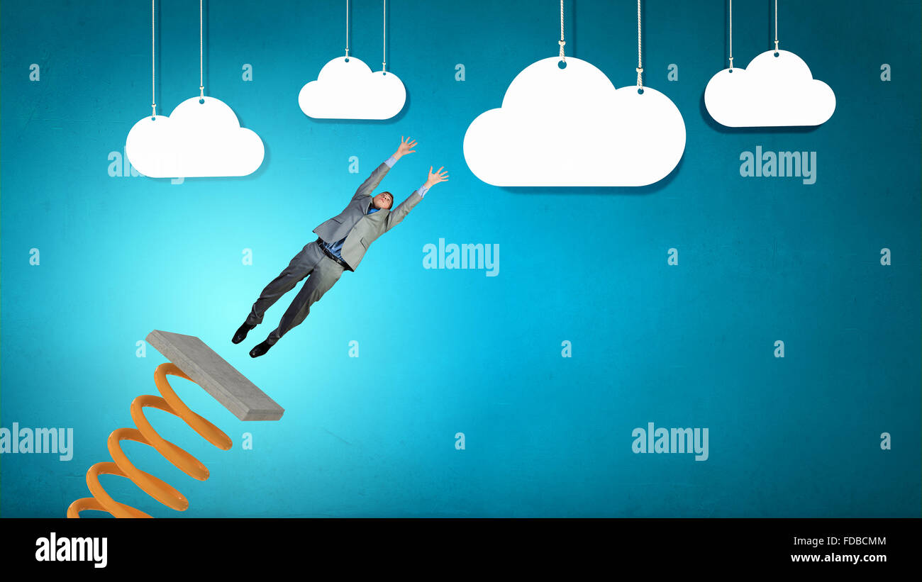 Businessman jumping on springboard as progress concept Stock Photo - Alamy