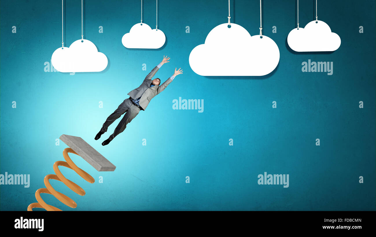 Businessman jumping on springboard as progress concept Stock Photo - Alamy