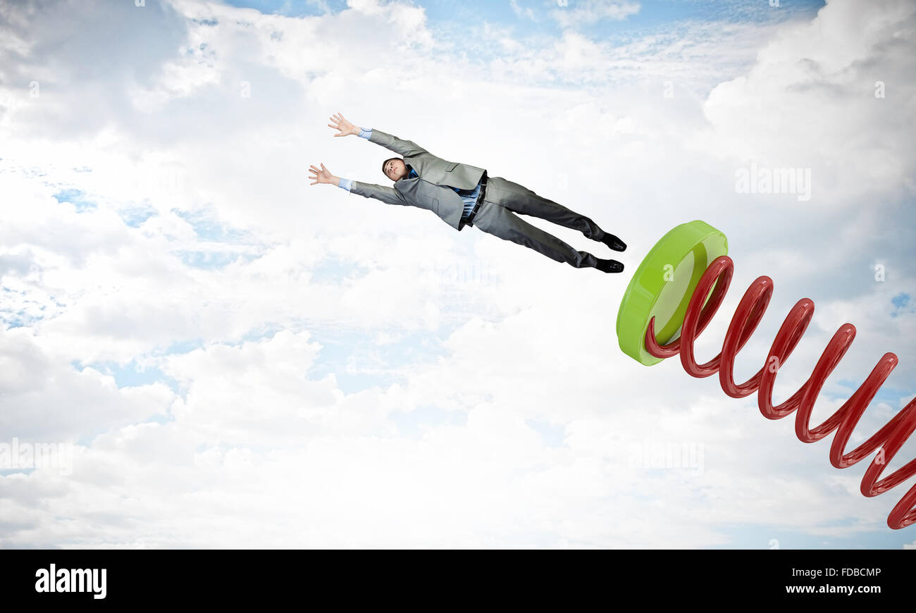 Businessman jumping on springboard as progress concept Stock Photo - Alamy