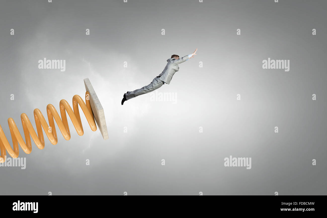 Businessman jumping on springboard as progress concept Stock Photo - Alamy
