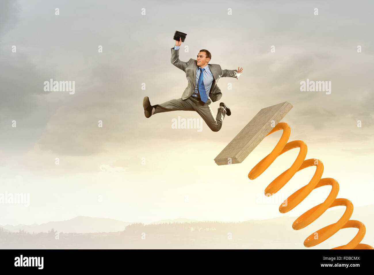 Businessman jumping on springboard as progress concept Stock Photo - Alamy