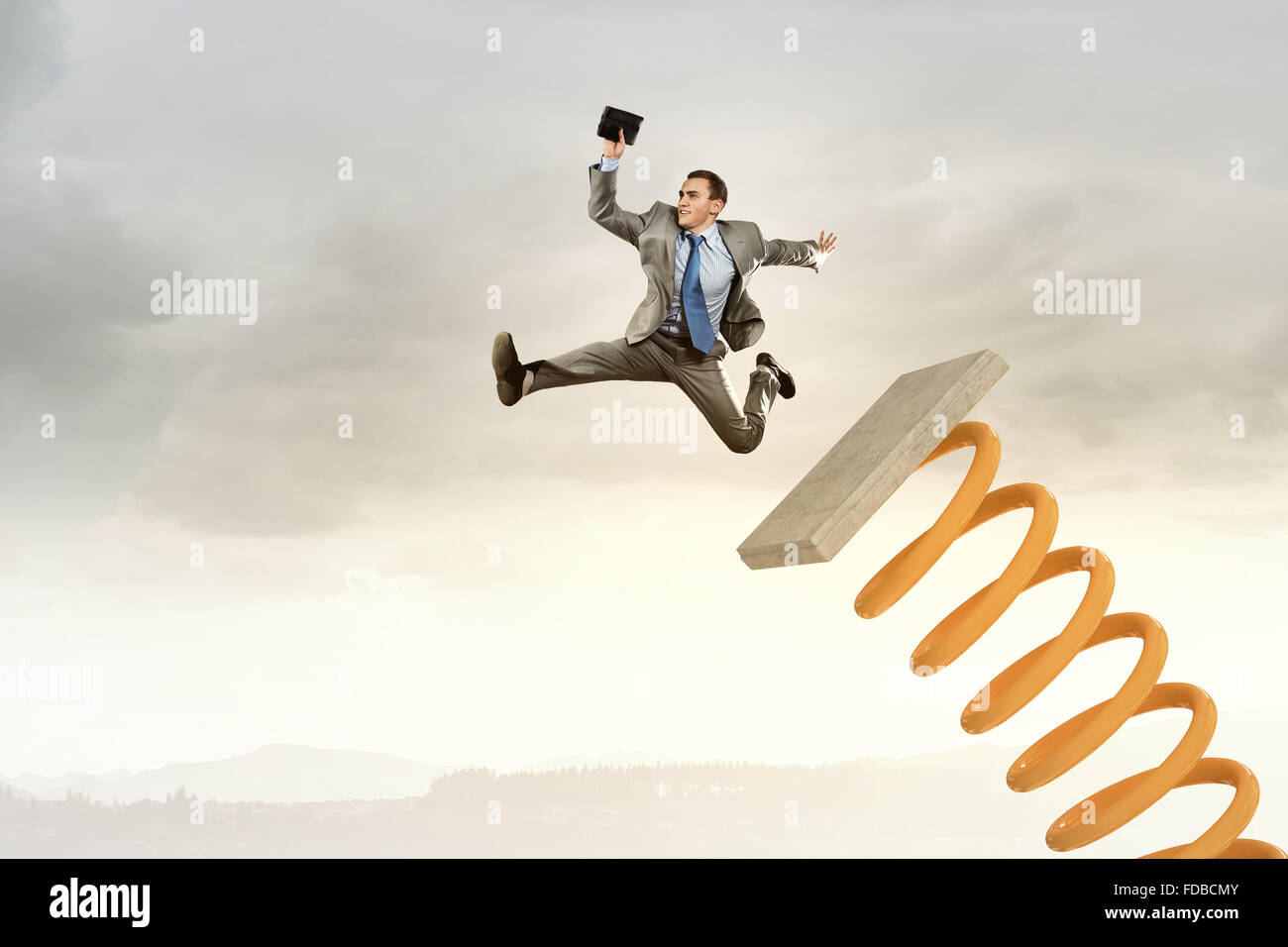 Businessman jumping on springboard as progress concept Stock Photo - Alamy
