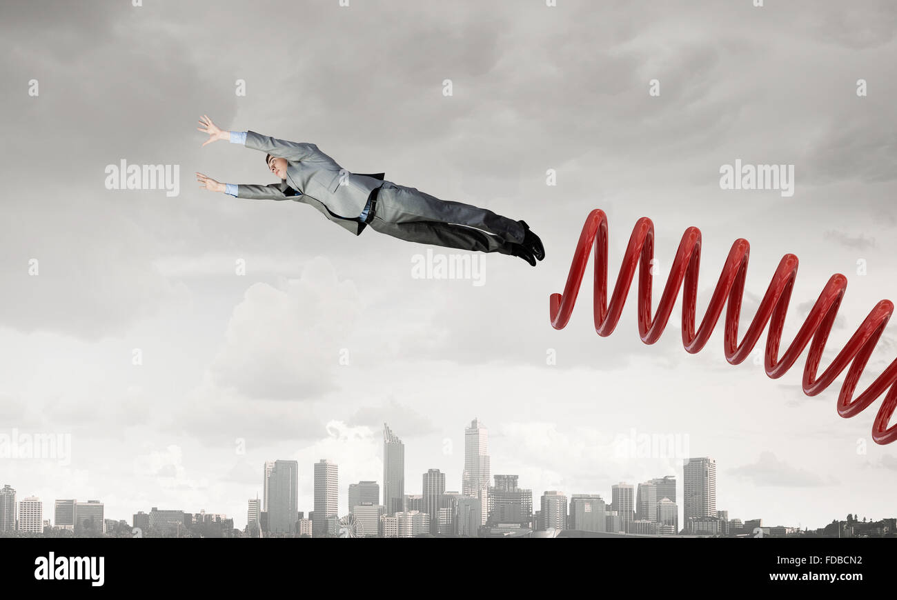 Businessman jumping on springboard as progress concept Stock Photo - Alamy