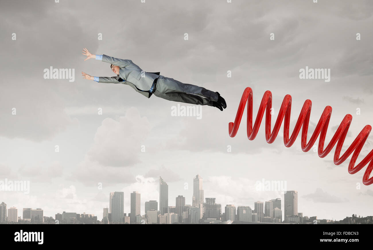 Businessman jumping on springboard as progress concept Stock Photo - Alamy