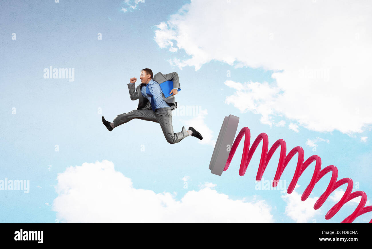 Businessman jumping on springboard as progress concept Stock Photo - Alamy