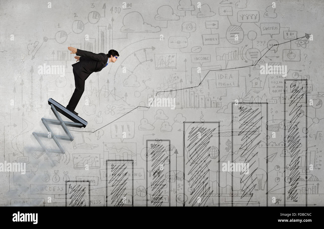 Businessman jumping on springboard as progress concept Stock Photo - Alamy