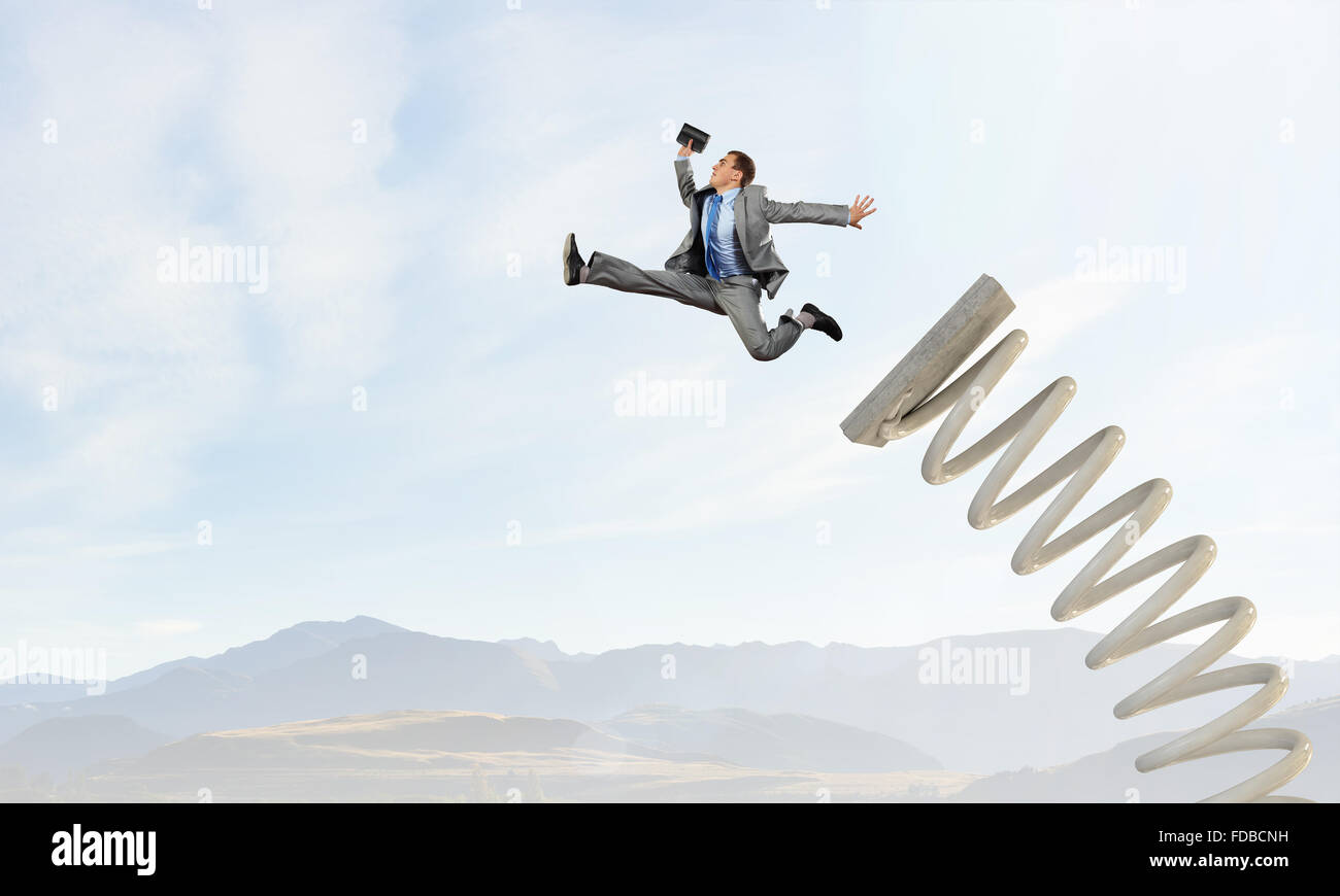 Businessman jumping on springboard as progress concept Stock Photo - Alamy