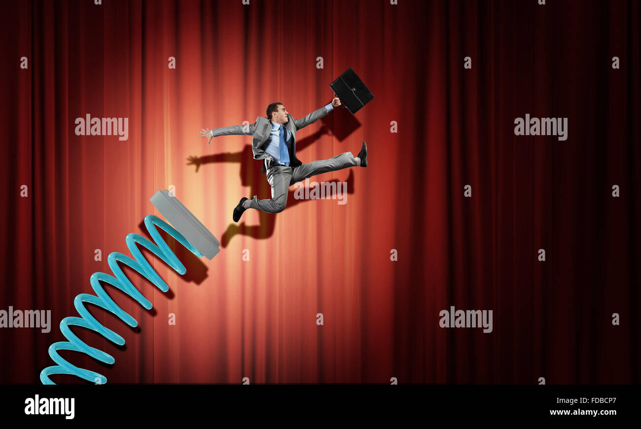 Businessman jumping on springboard as progress concept Stock Photo - Alamy