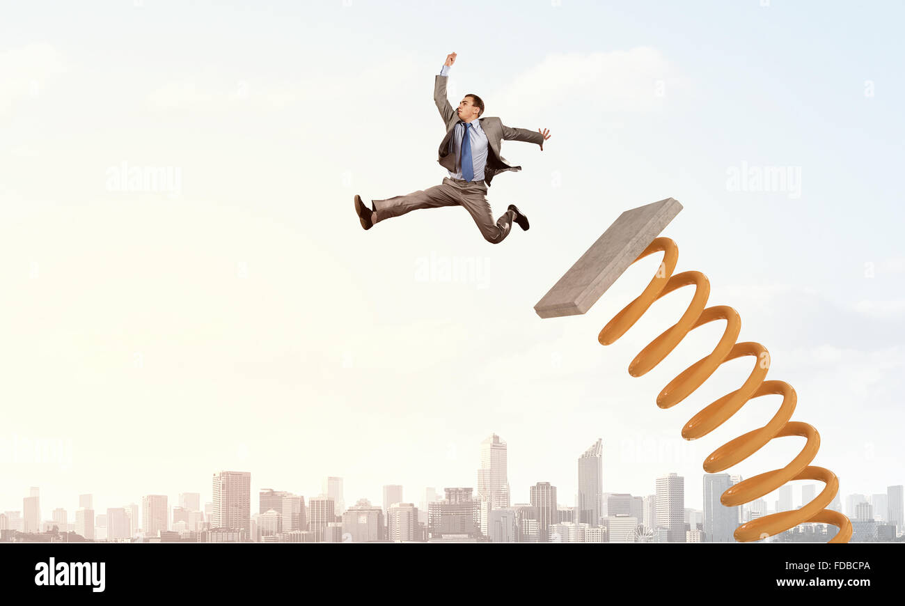 Businessman jumping on springboard as progress concept Stock Photo - Alamy