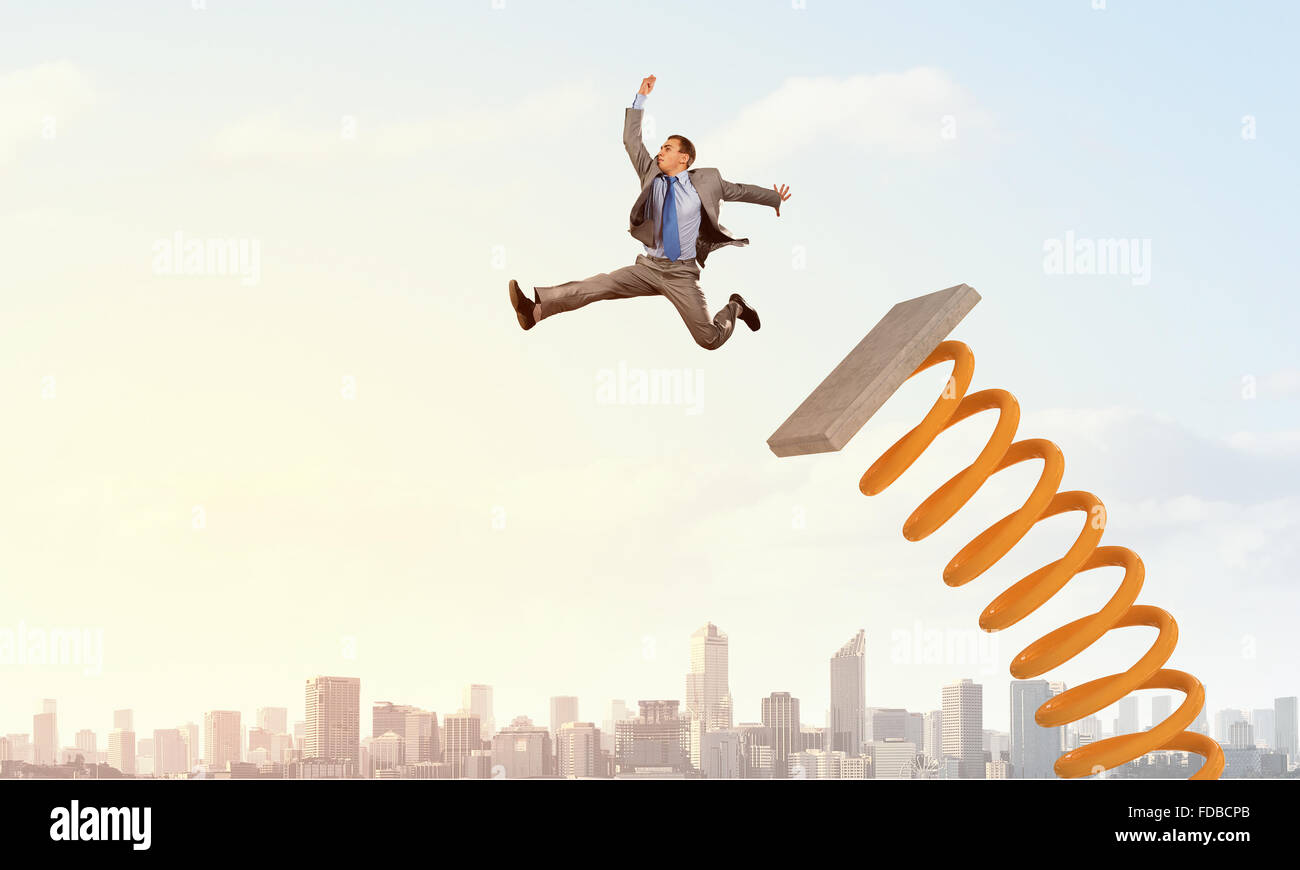 Businessman jumping on springboard as progress concept Stock Photo - Alamy