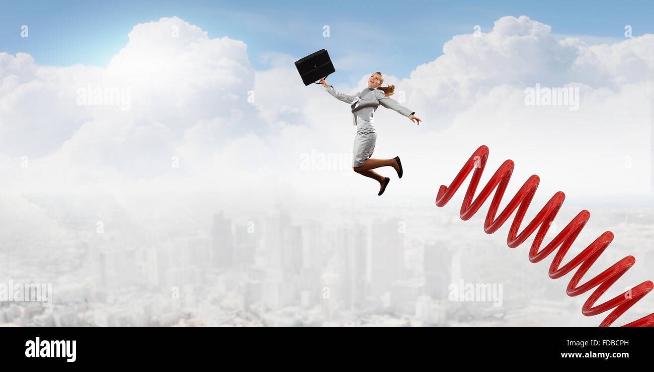 Businesswoman jumping on springboard as progress concept Stock Photo ...