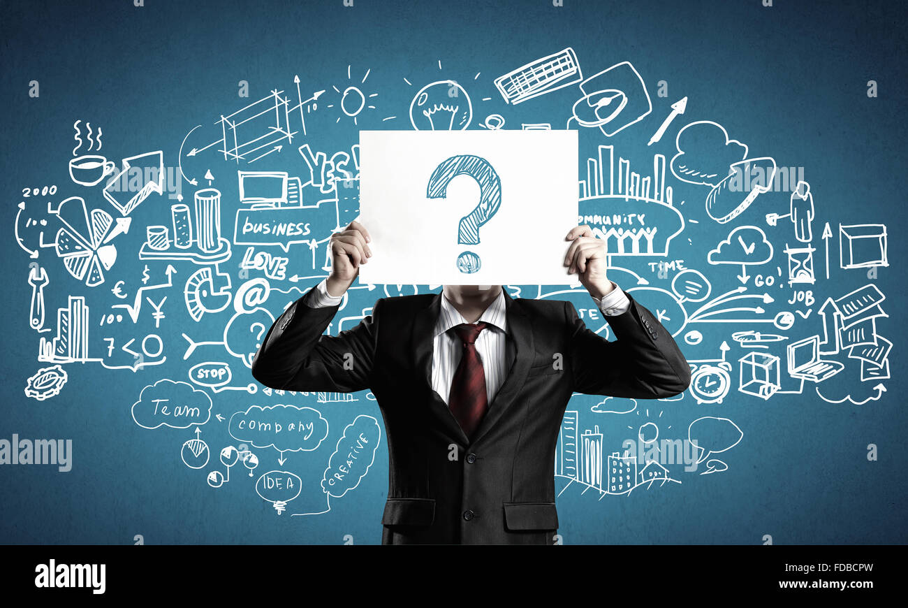 Businessman holding paper sheet with question mark in front of his face ...