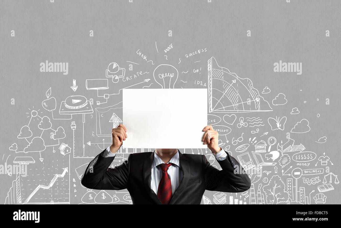 Businessman hiding his face behind paper list Stock Photo - Alamy