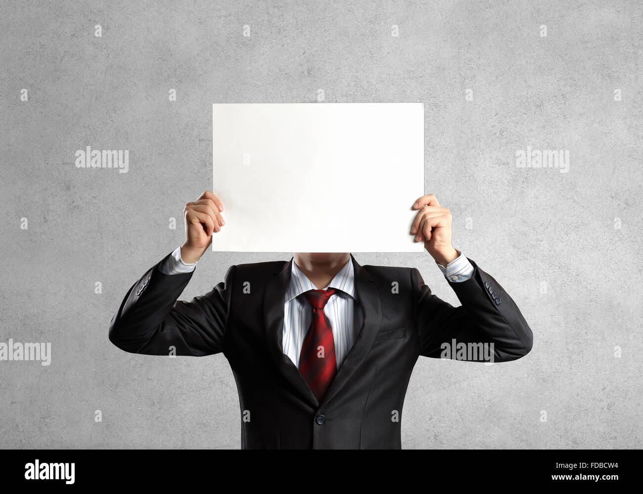 Businessman hiding his face behind paper list Stock Photo - Alamy