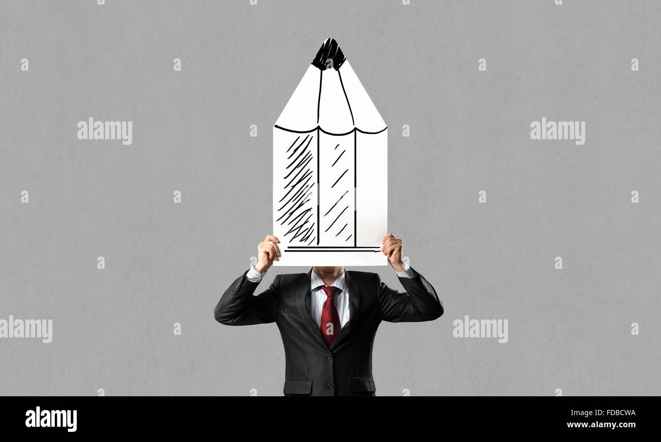 Businessman hiding his face behind pencil paper sheet Stock Photo - Alamy