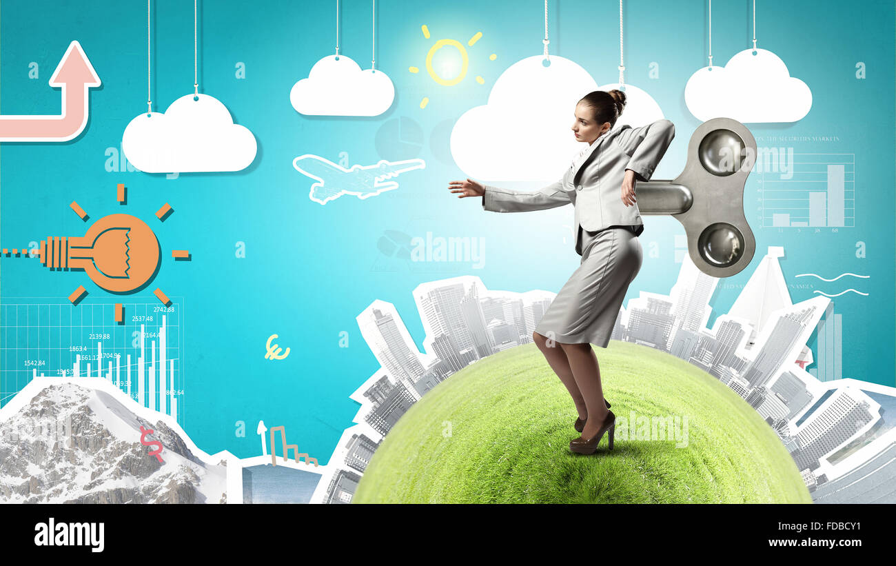 Young businesswoman walking with wind up key in his back Stock Photo ...
