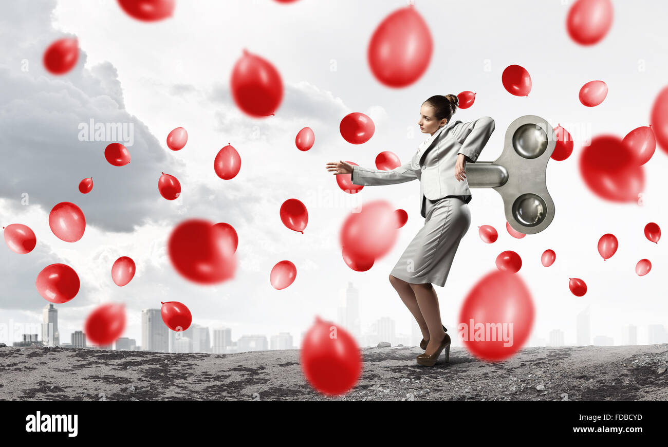 Young businesswoman walking with wind up key in his back Stock Photo ...
