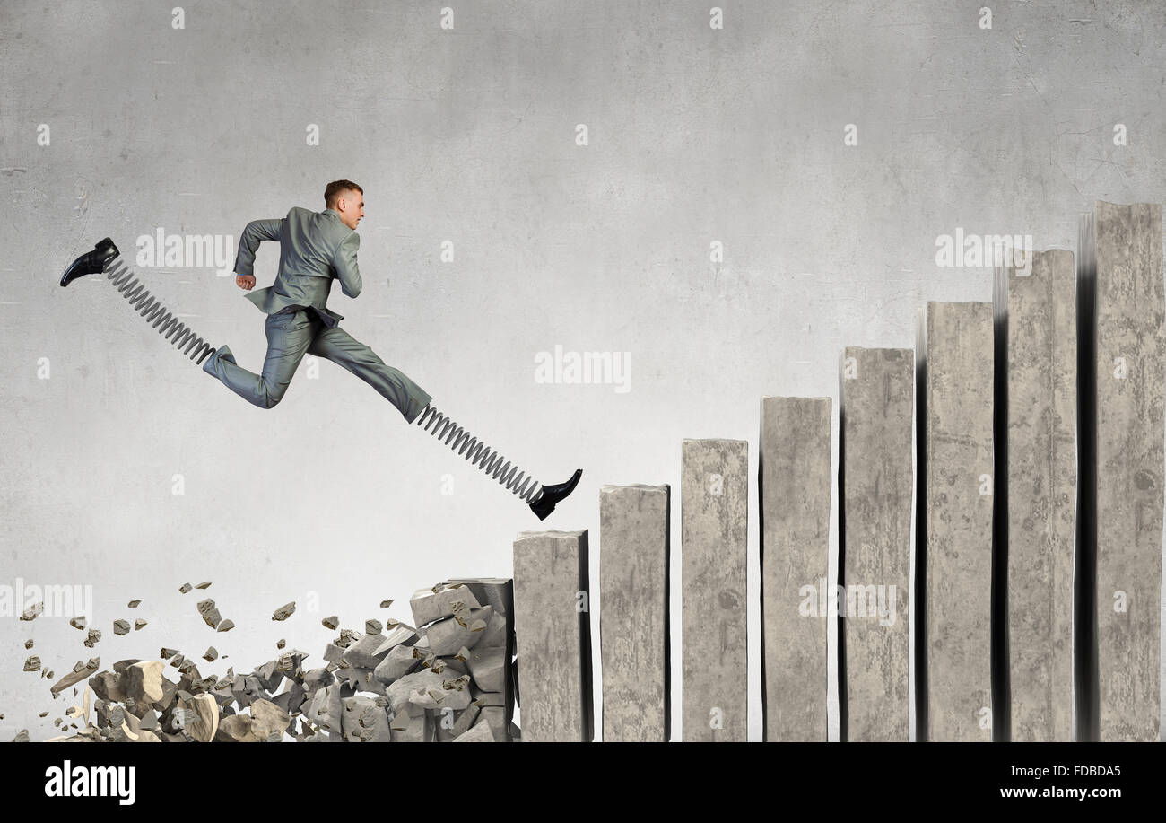 Businessman in suit jumping with big springs on feet Stock Photo - Alamy