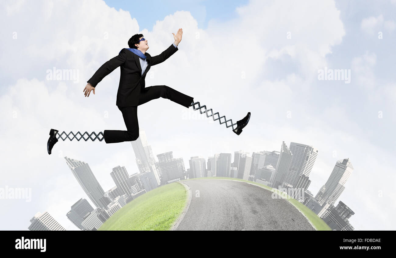 Businessman in suit jumping with big springs on feet Stock Photo - Alamy