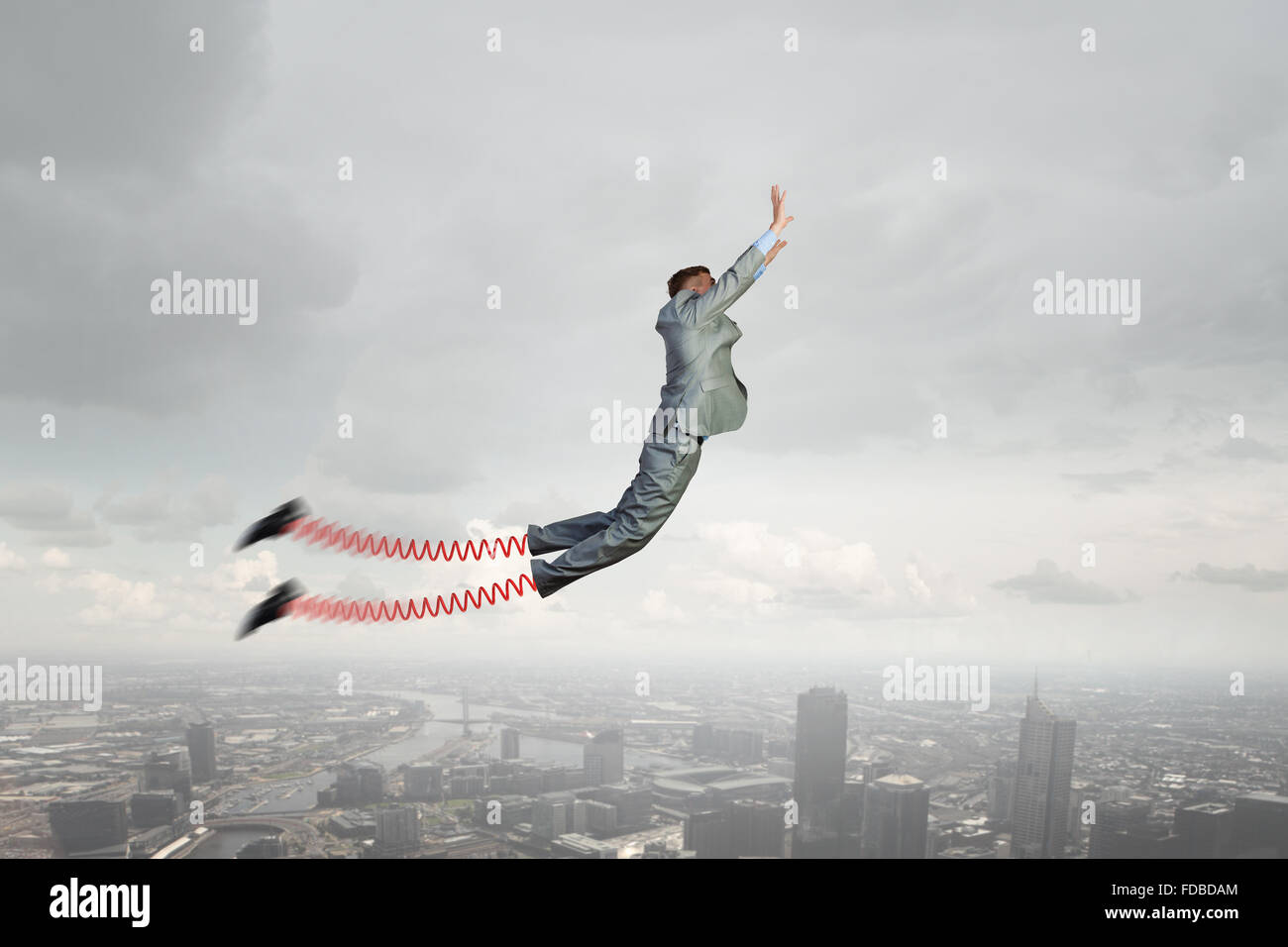 Businessman in suit jumping with big springs on feet Stock Photo - Alamy